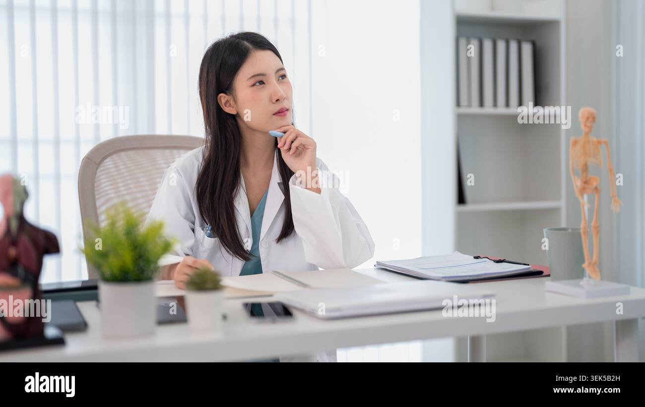 Asian women doctor thinking solution planning strategy sitting desk ...