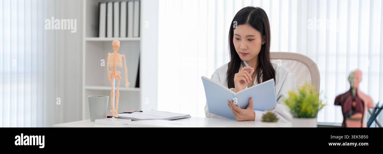 Asian female doctor reading medical textbook studying research at ...