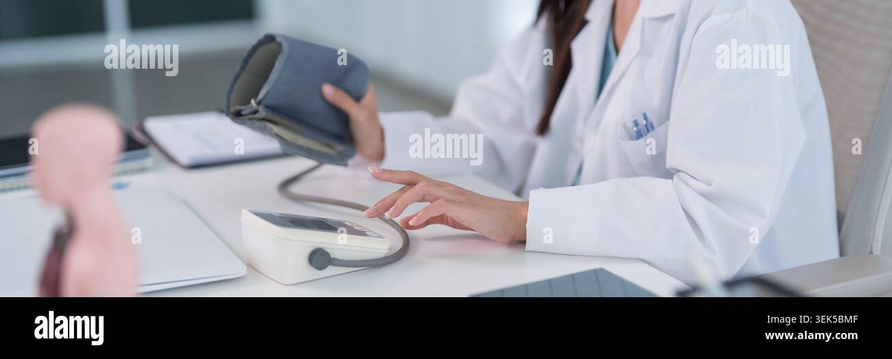 female doctor measuring patient blood pressure with medical device ...