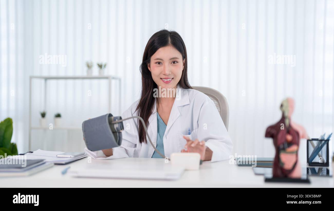 Asian female doctor in white coat explaining medical information during ...