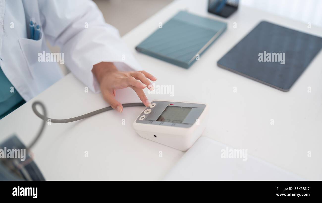 healthcare professional doctor hand using blood pressure monitor device ...