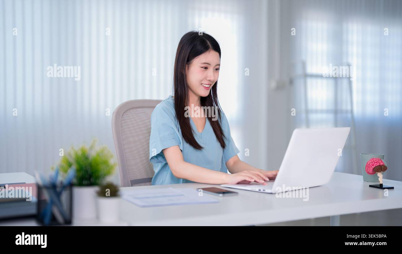 young Asian woman professional typing laptop computer working online ...