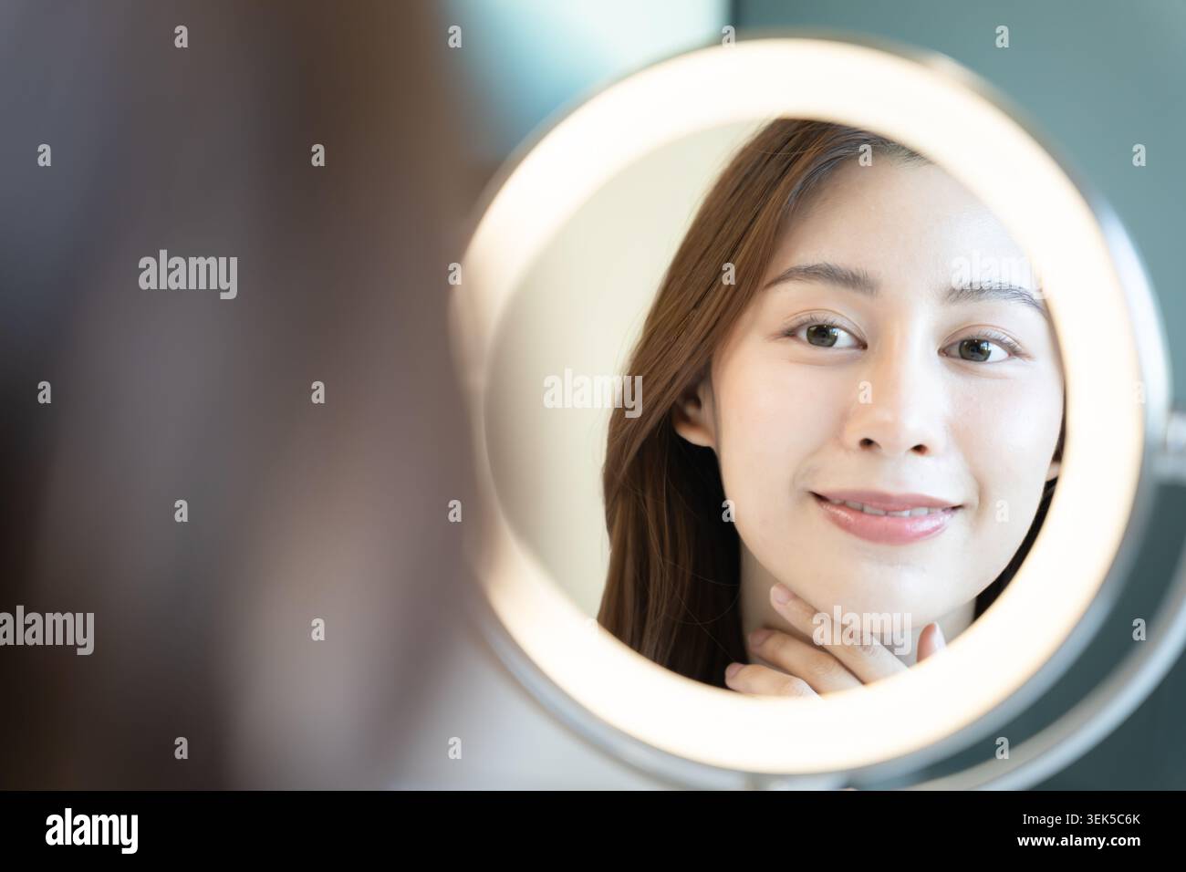 Beautiful asian woman make up, face of a healthy woman applying cream ...