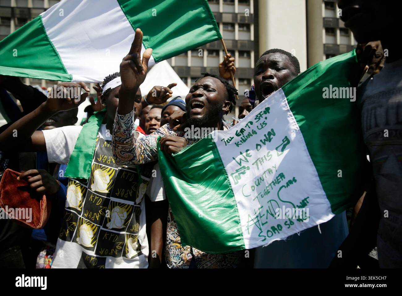 FILE - People hold banners as they demonstrate on the street to protest ...