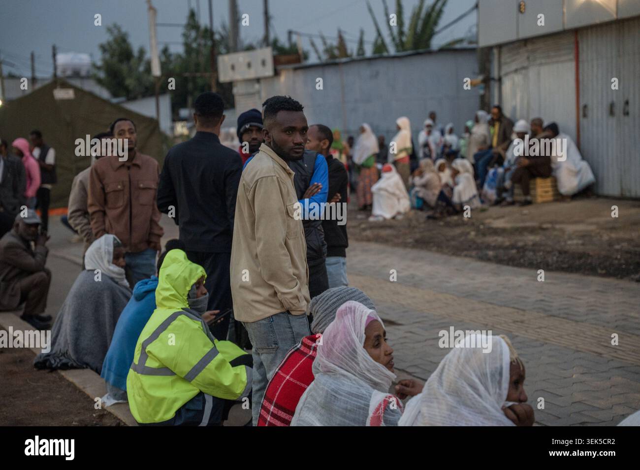 Ethiopians wait outside a polling station before casting their votes in ...