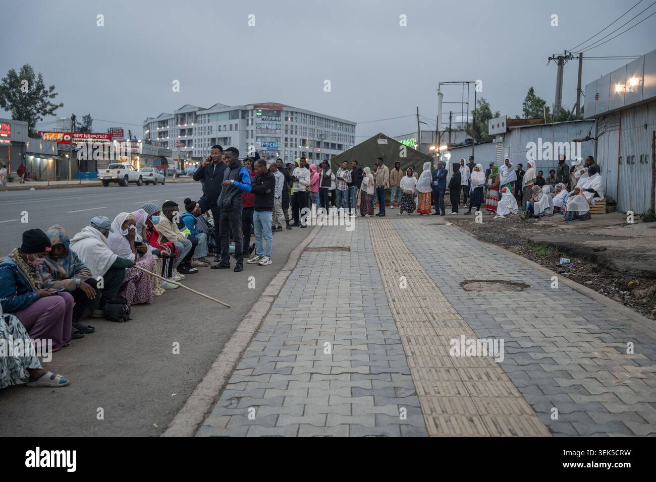 Ethiopians gather outside a polling station before casting their votes ...