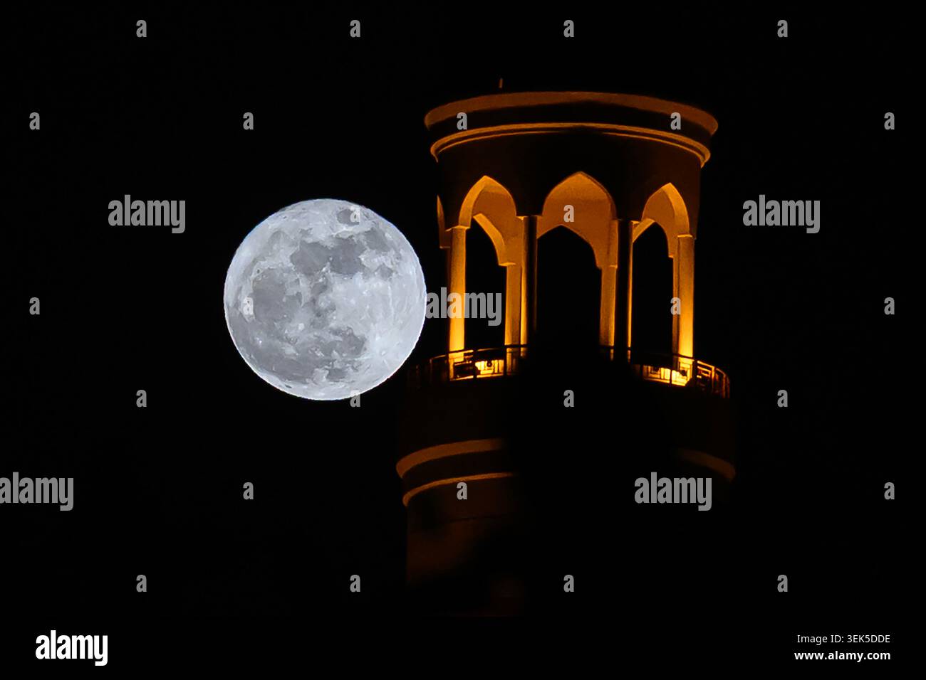The full moon, known as the Blue Moon, is seen behind the Al Fanar ...