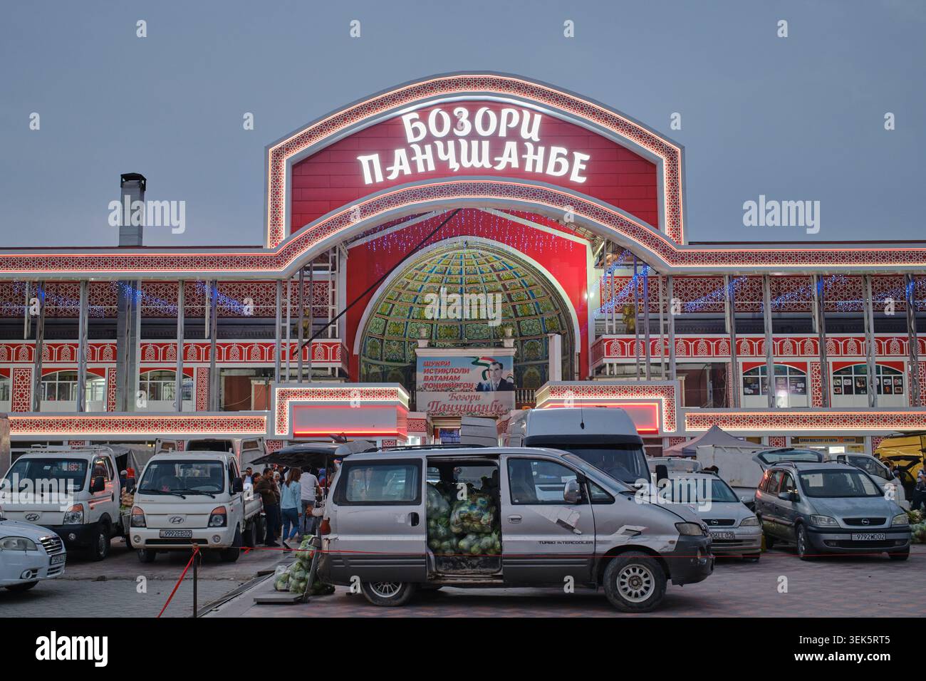 A car filled with cabbages sits parked outside Panjshanbe Bazaar in ...
