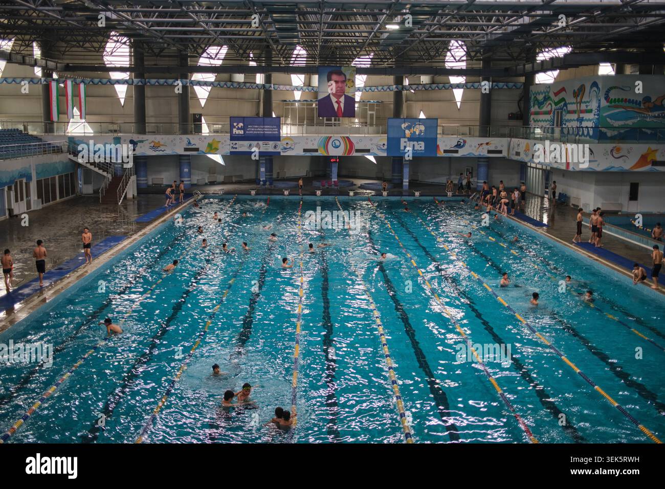 A portrait of Tajik President Emomali Rahmon hangs over a swimming pool ...
