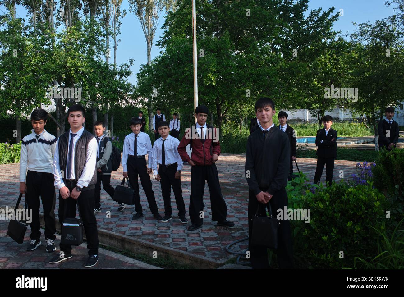Students pose for a photo outside their school in Istaravshan ...