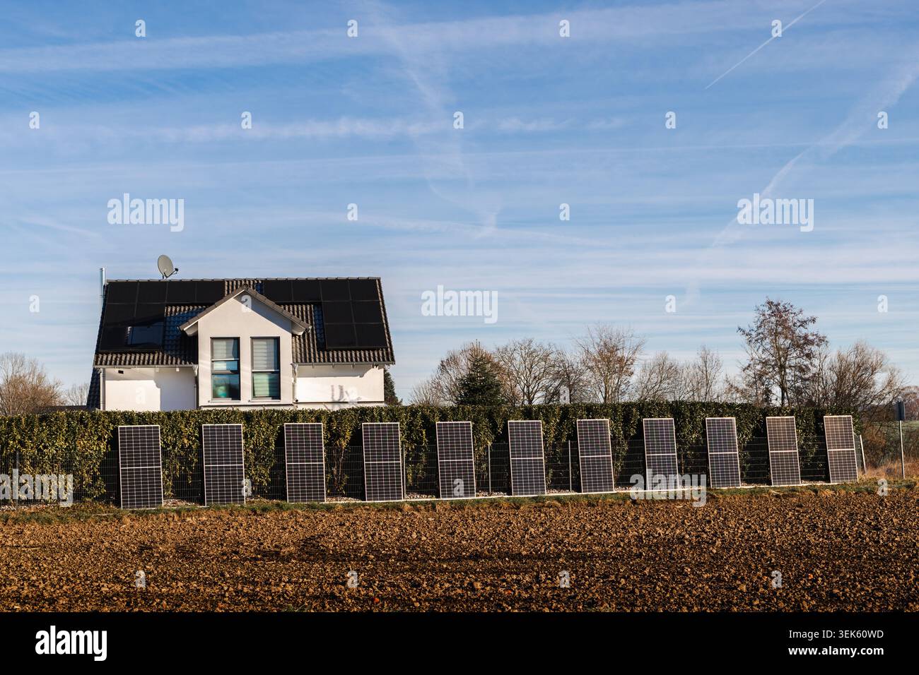 House with rooftop solar panels and ground mounted photovoltaic system ...