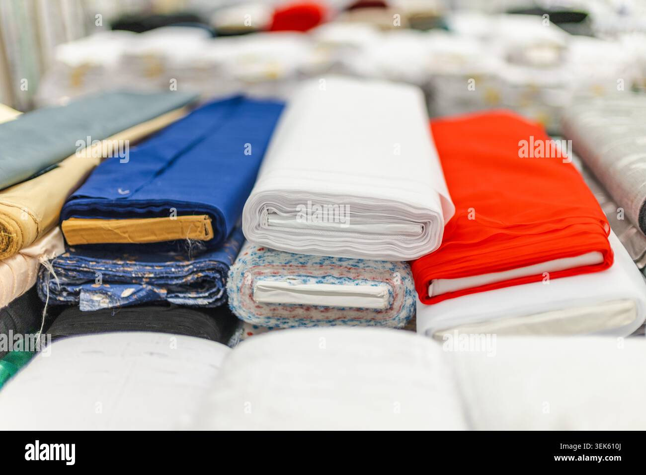 Colorful folded fabric and textile materials displayed in home ...