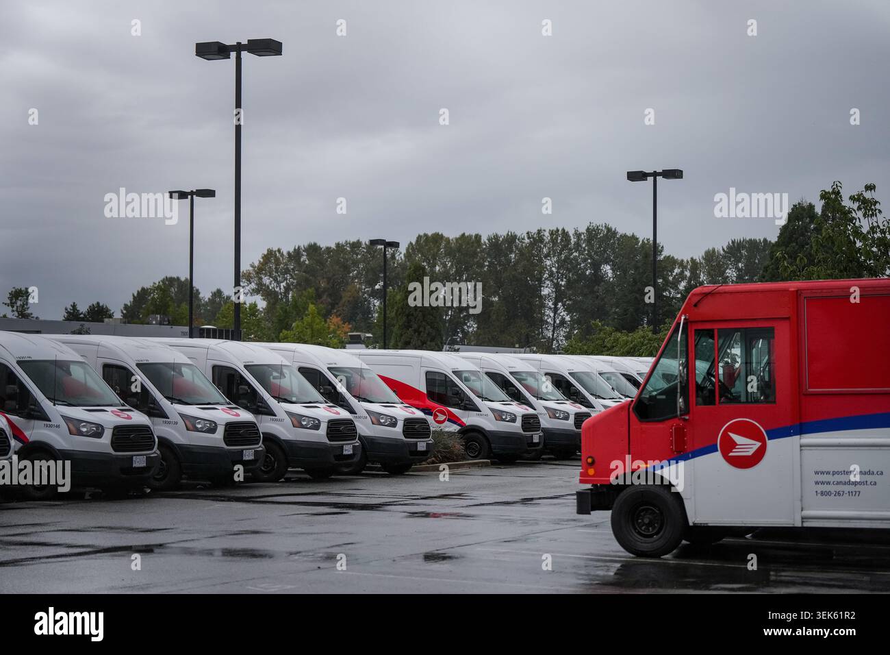 Vehicles sit idle at a Canada Post delivery depot, in Burnaby, B.C., on ...