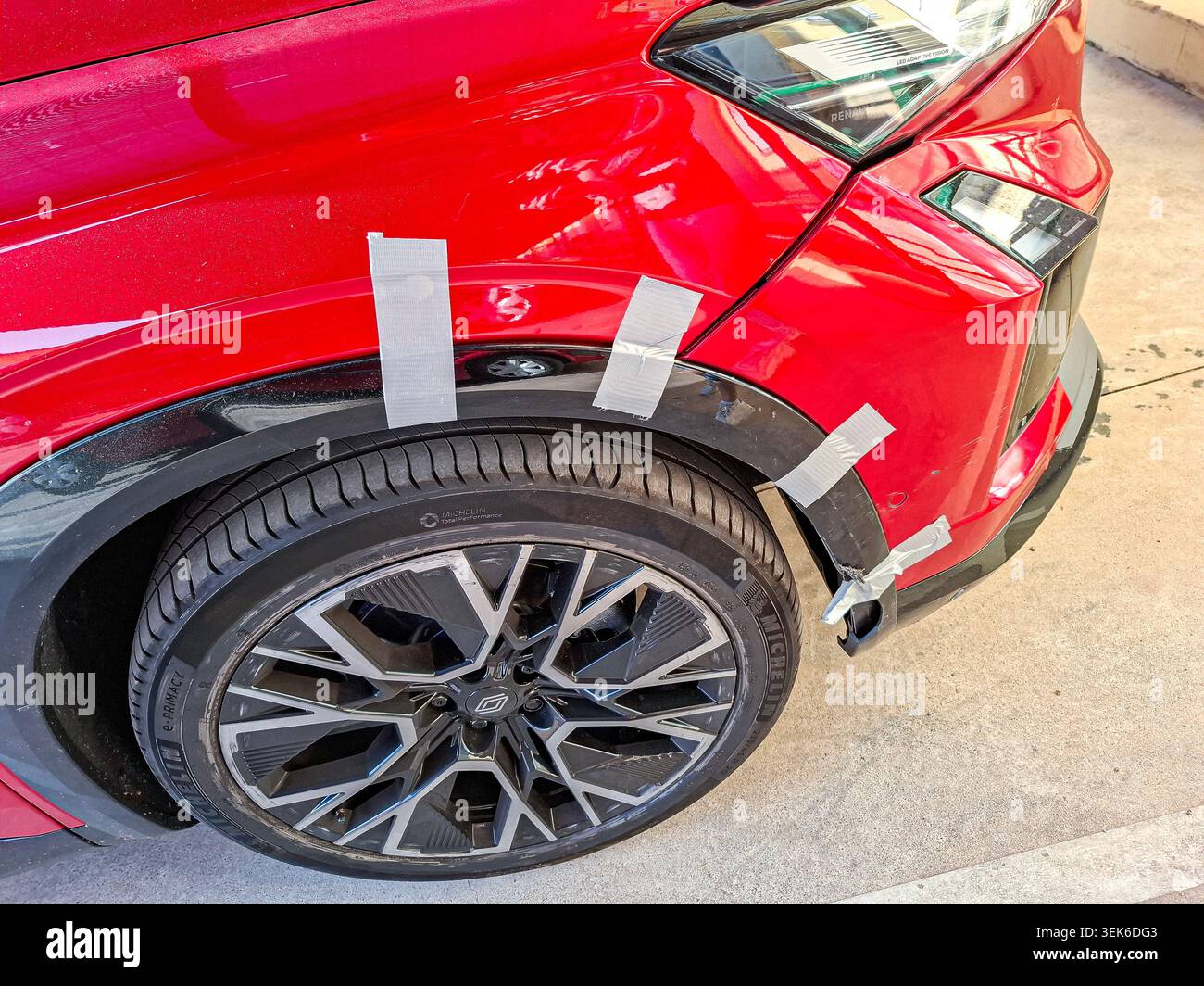 Denia, SPAIN - May 19, 2026. bright red car is parked by the roadside ...