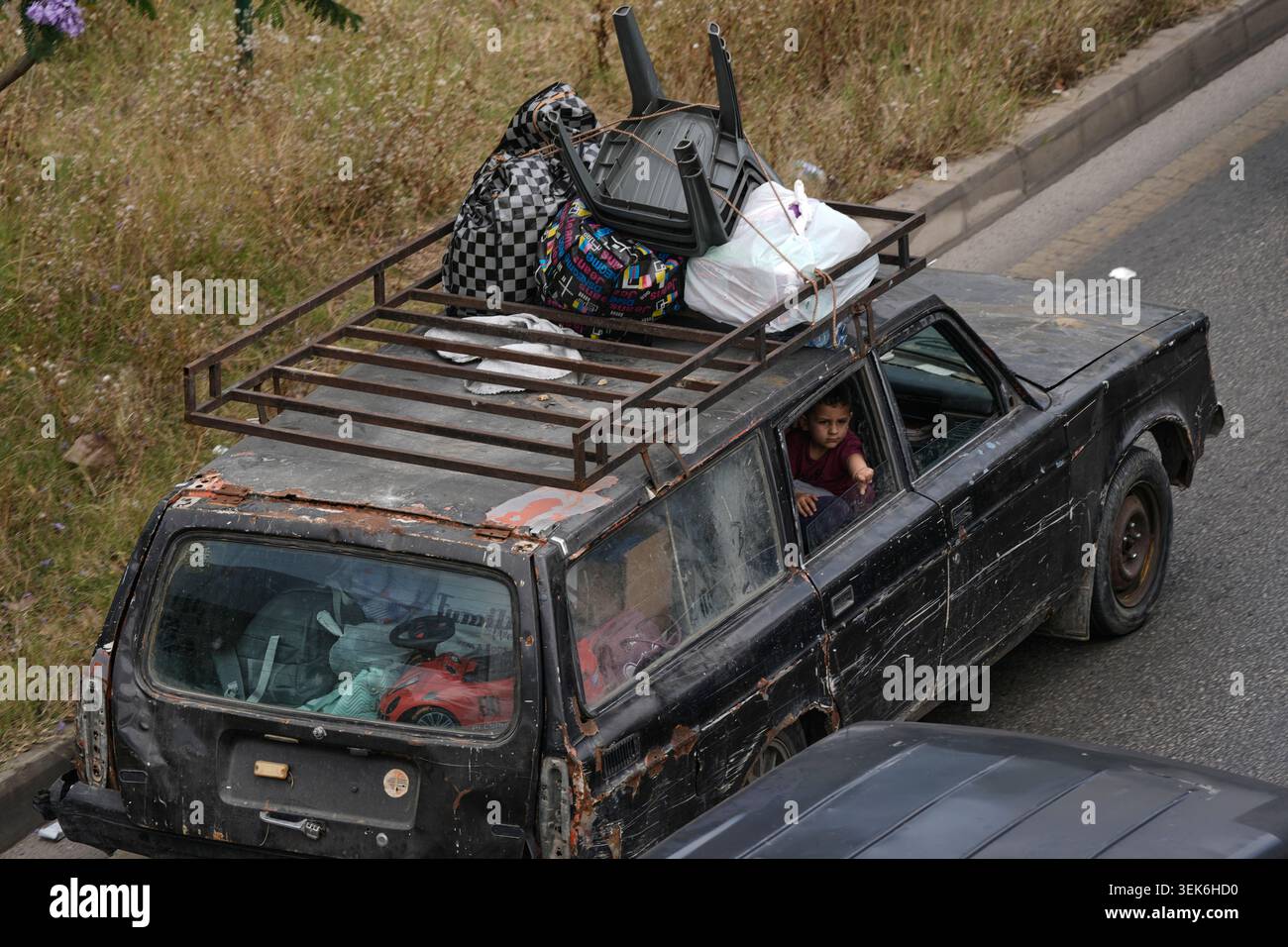 A family flees following an Israeli threat to strike Dahiyeh, Beirut's ...