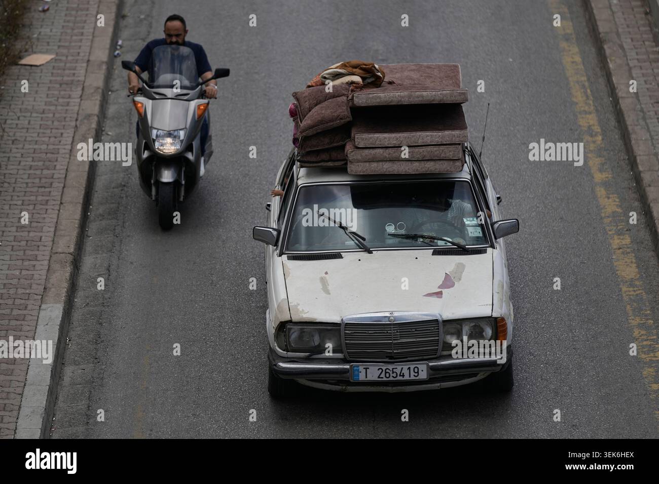 A family flees following an Israeli threat to strike Dahiyeh, Beirut's ...