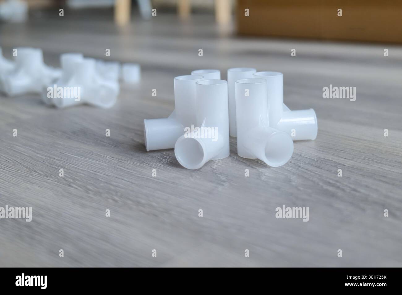 White Plastic Pipe Connectors on Wooden Background Stock Photo - Alamy