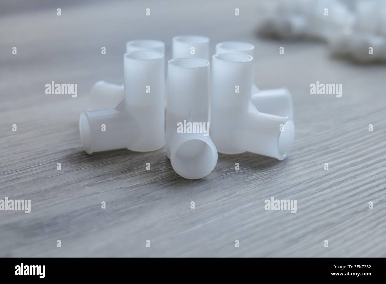 White Plastic Pipe Connectors on Wooden Background Stock Photo - Alamy