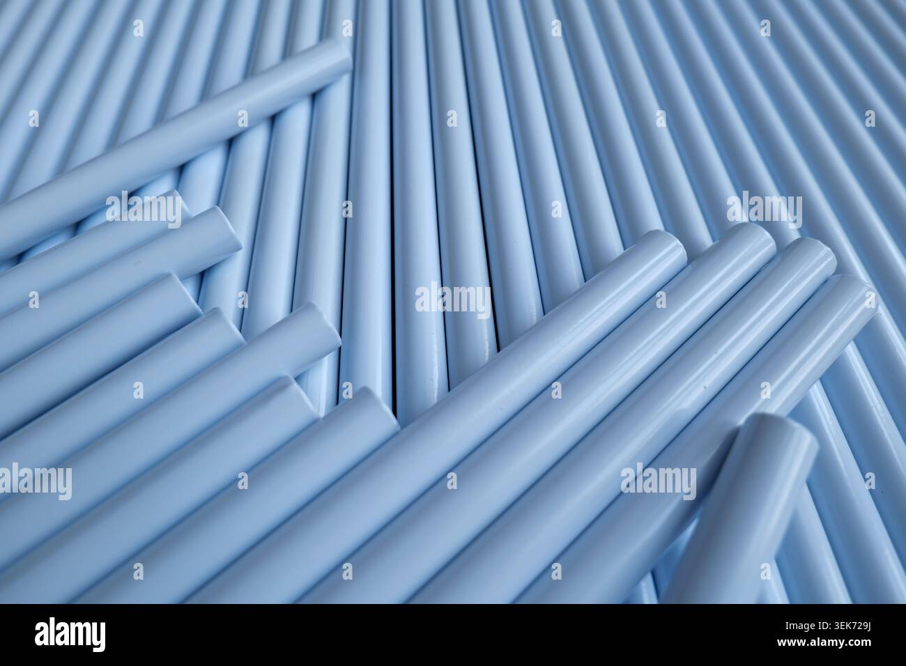 Close up of light blue metal pipes stacked together Stock Photo - Alamy