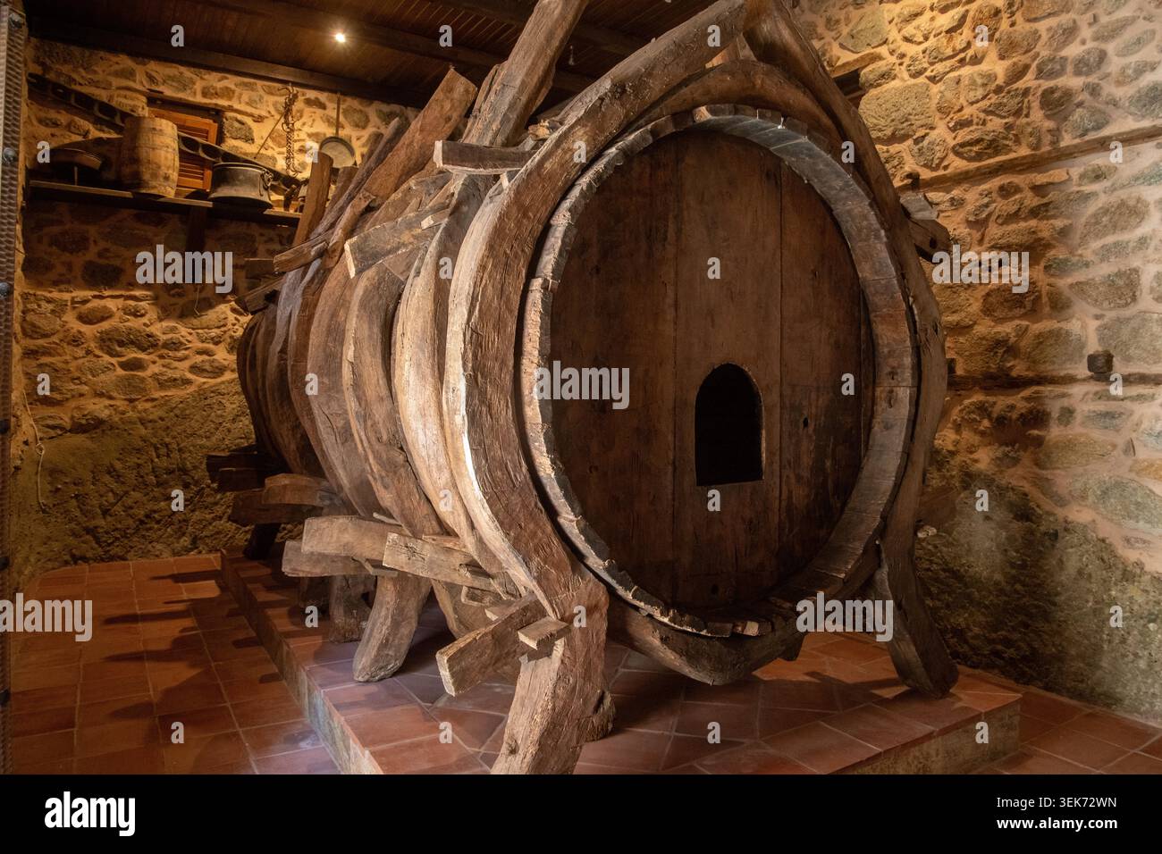 Explore the charm of a vintage wooden barrel in a stone cellar ...