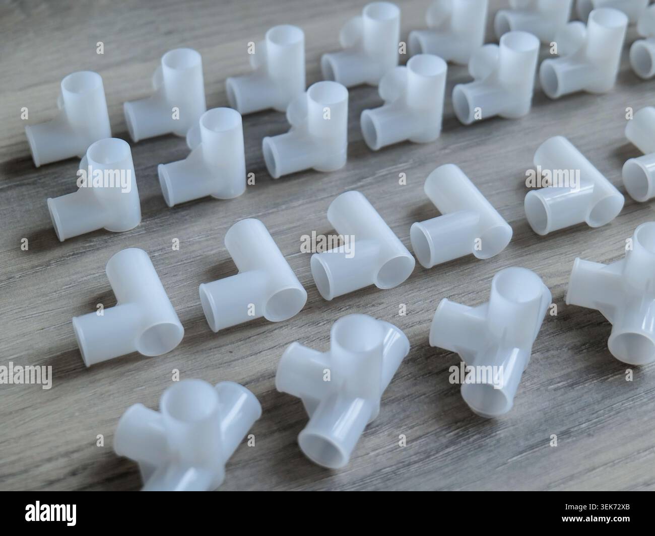 White Plastic Connectors for DIY Projects on Wooden Background Stock ...