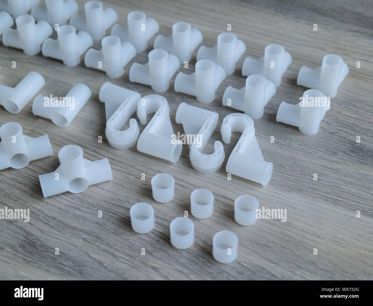 White Plastic Connectors for DIY Projects on Wooden Background Stock ...