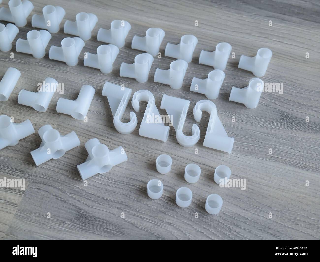 White Plastic Connectors for DIY Projects on Wooden Background Stock ...