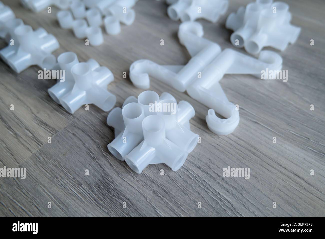 White Plastic Connectors for DIY Projects on Wooden Background Stock ...