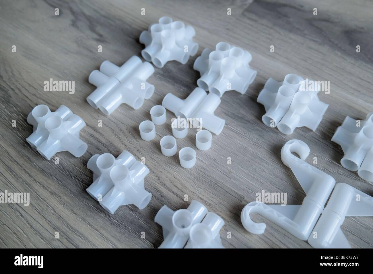 White Plastic Connectors for DIY Projects on Wooden Background Stock ...