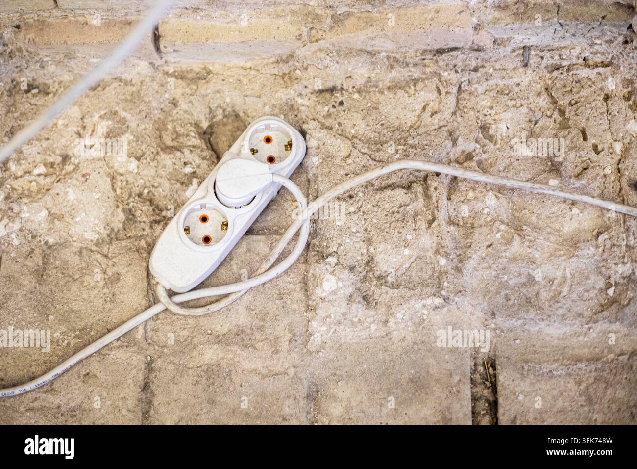 A power strip with an extension cord and a wire on the floor Stock ...