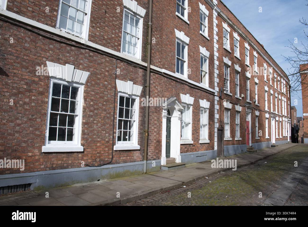 Georgian terraced red brick houses in Abbey Square in Cheste in Spring ...