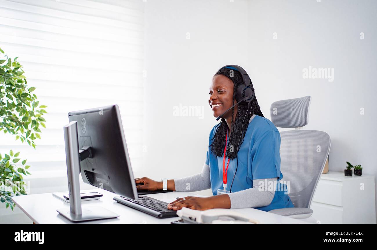 Female healthcare worker wearing headset communicating online with ...