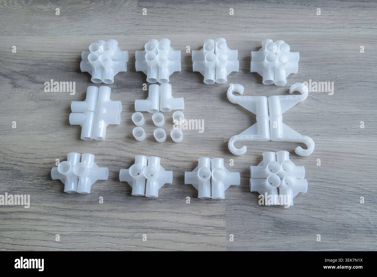 White Plastic Connectors for DIY Projects on Wooden Background Stock ...