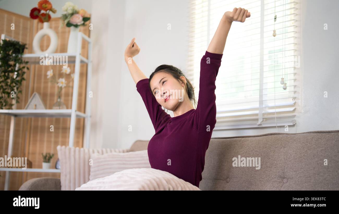 young Asian women waking up stretch arms relax morning routine bedroom ...