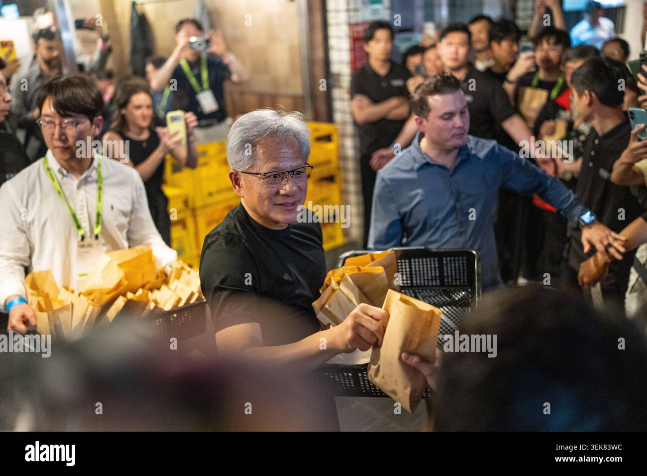 Jensen Huang, President and CEO of NVIDIA handing out food to fans ...