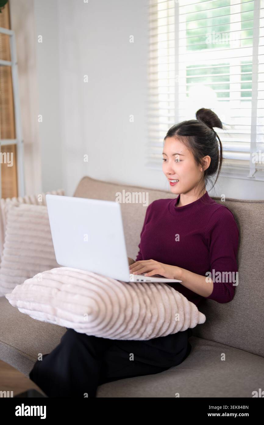 Asian woman professional using laptop computer for remote work sitting ...