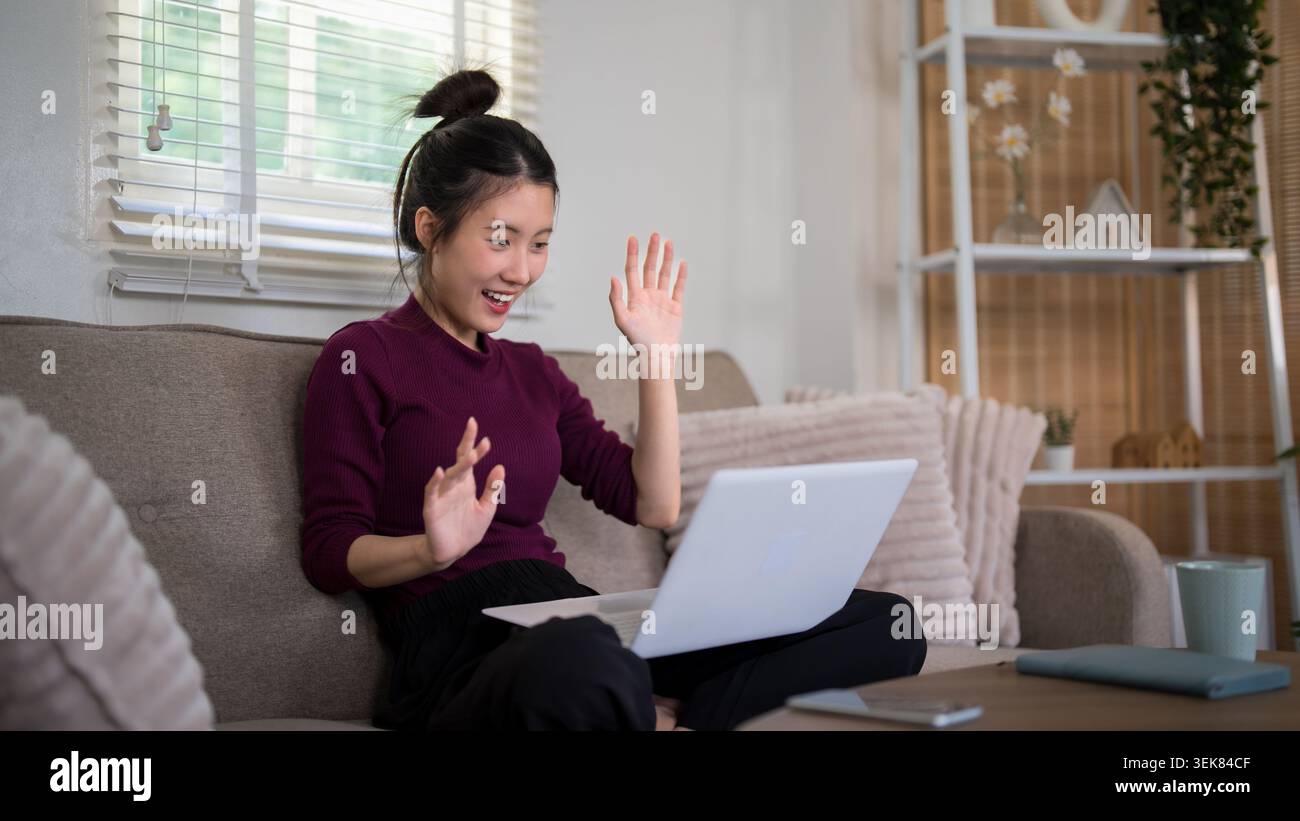 young asian woman having video call consultation waving greeting using ...