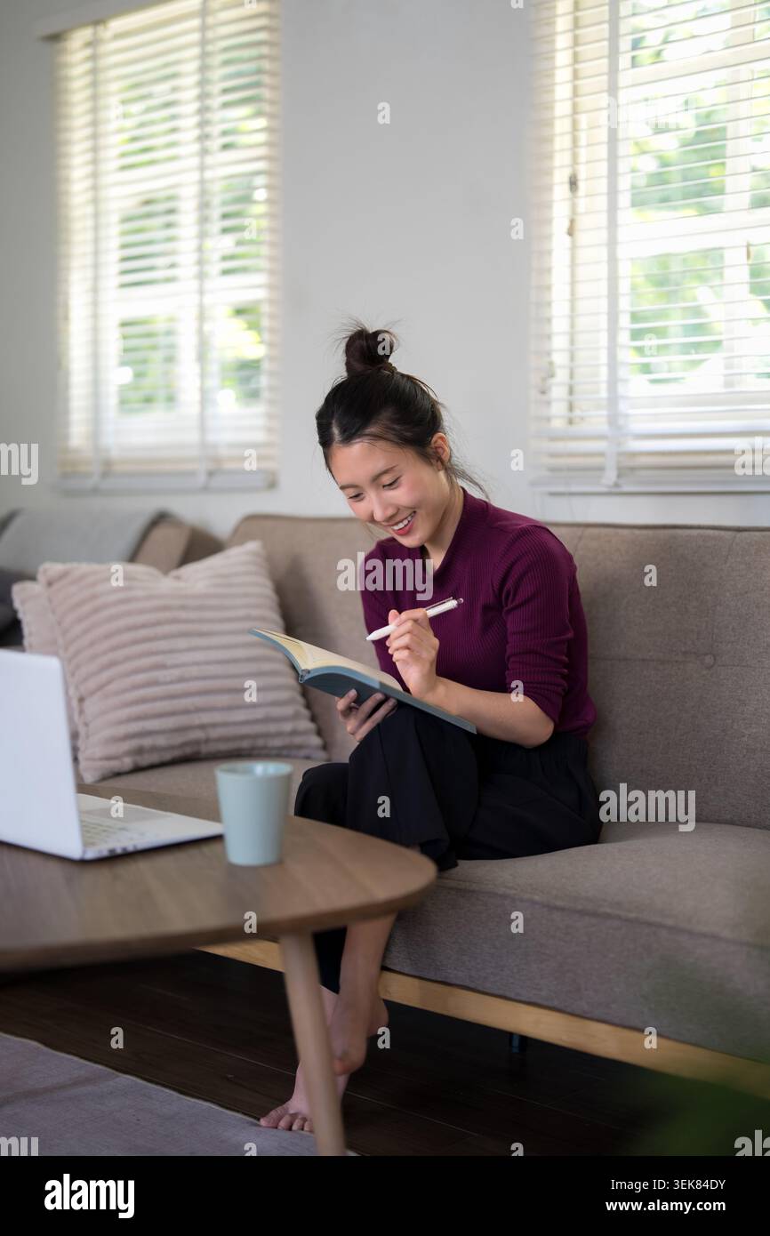Asian adult female medical professional writing in journal notebook ...