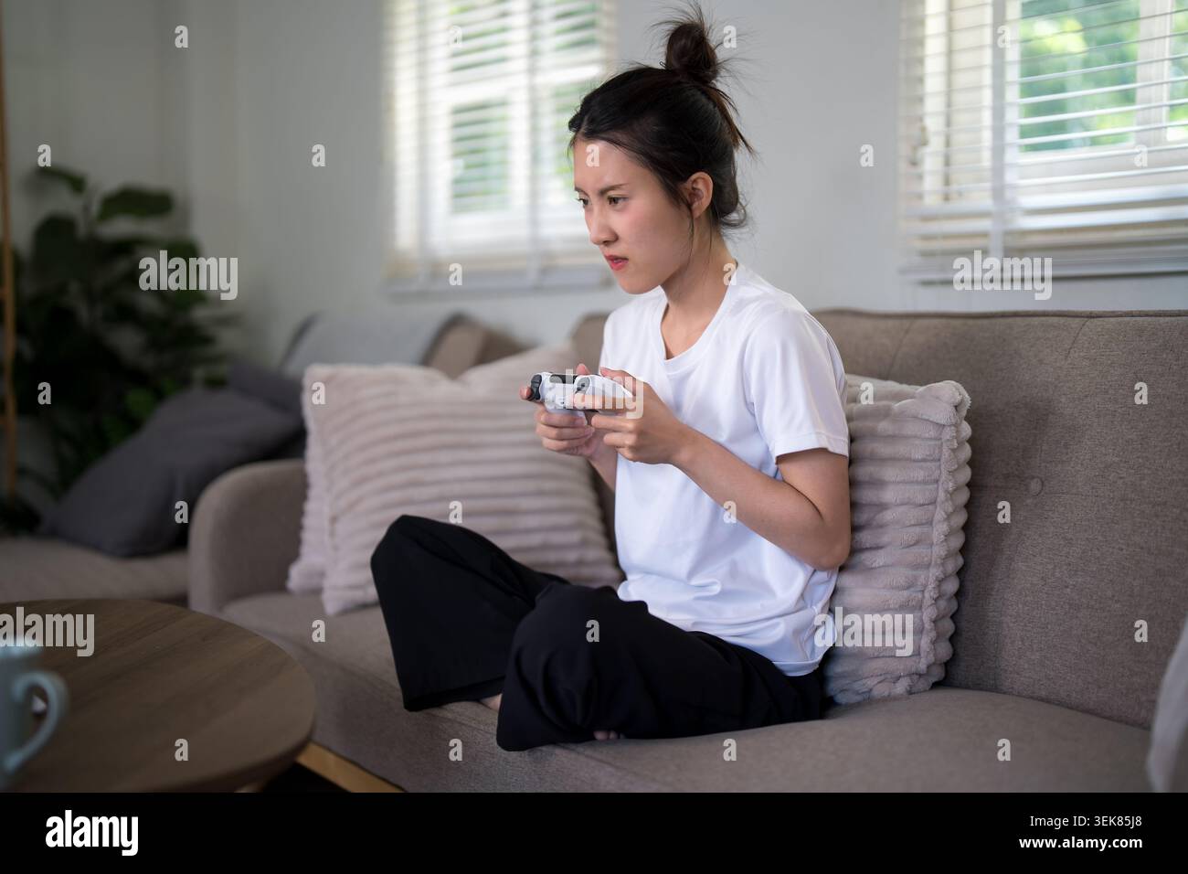 Asian woman checking blood glucose level with diabetes monitor device ...
