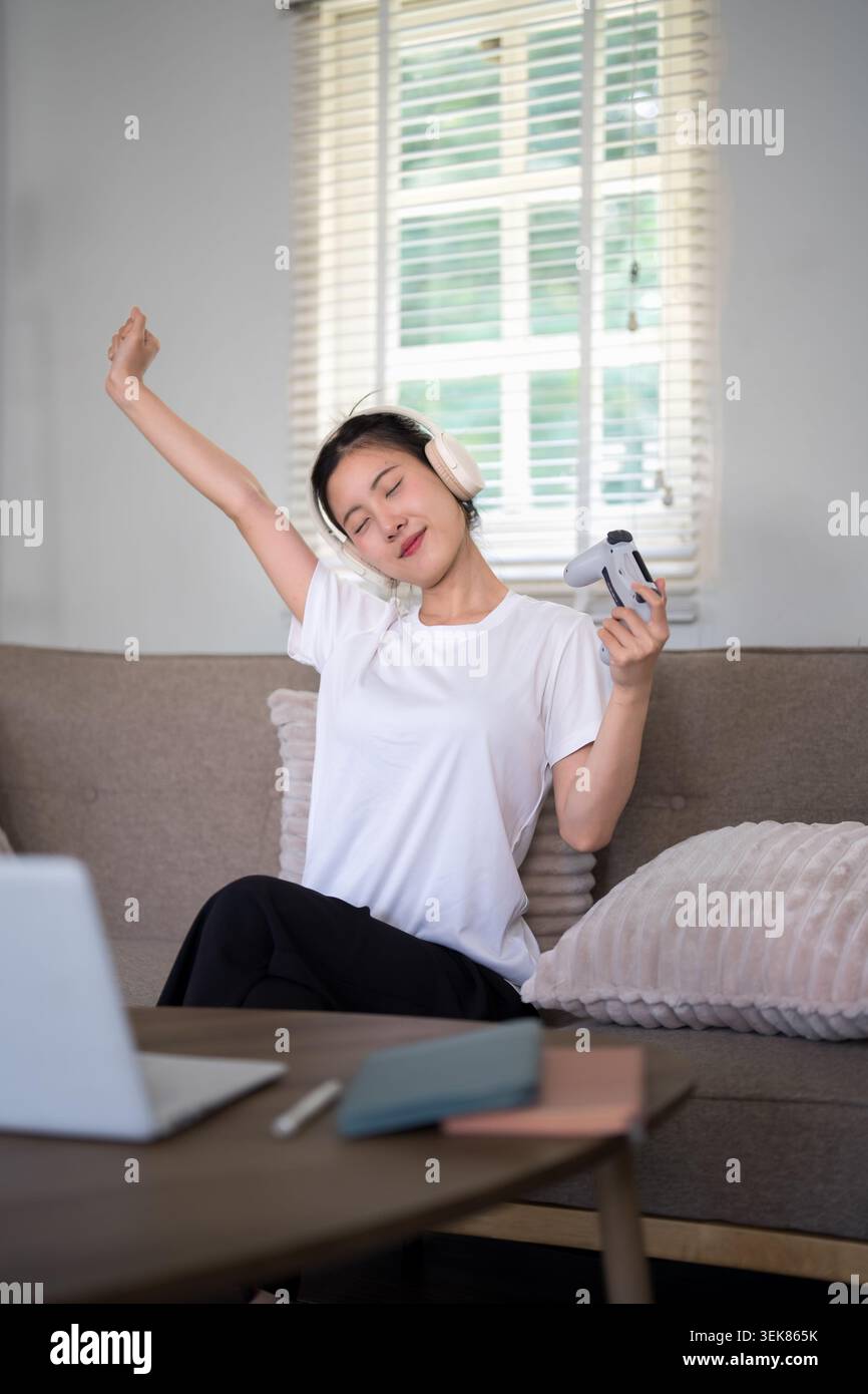 Asian woman professional stretching during remote work break holding ...