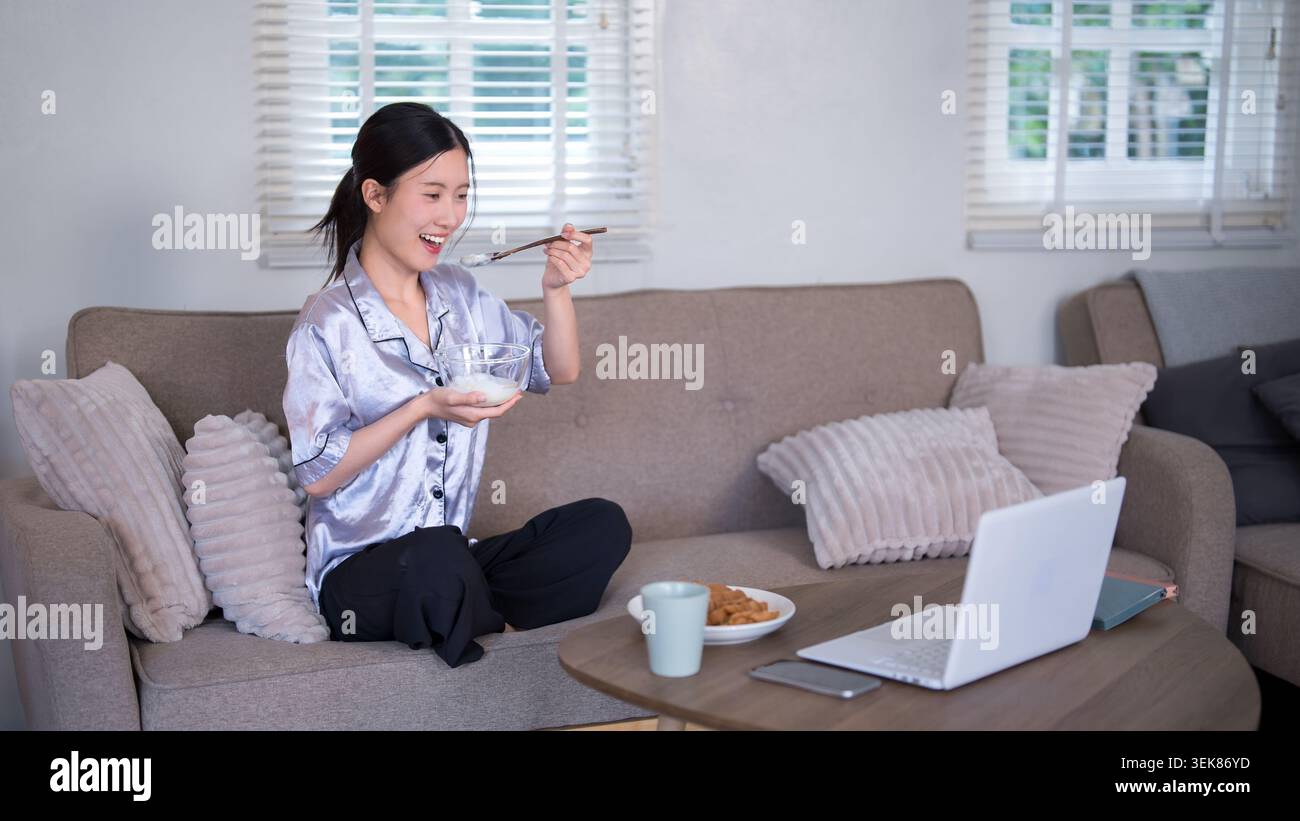 young Asian women doctor eating healthy breakfast while working on ...