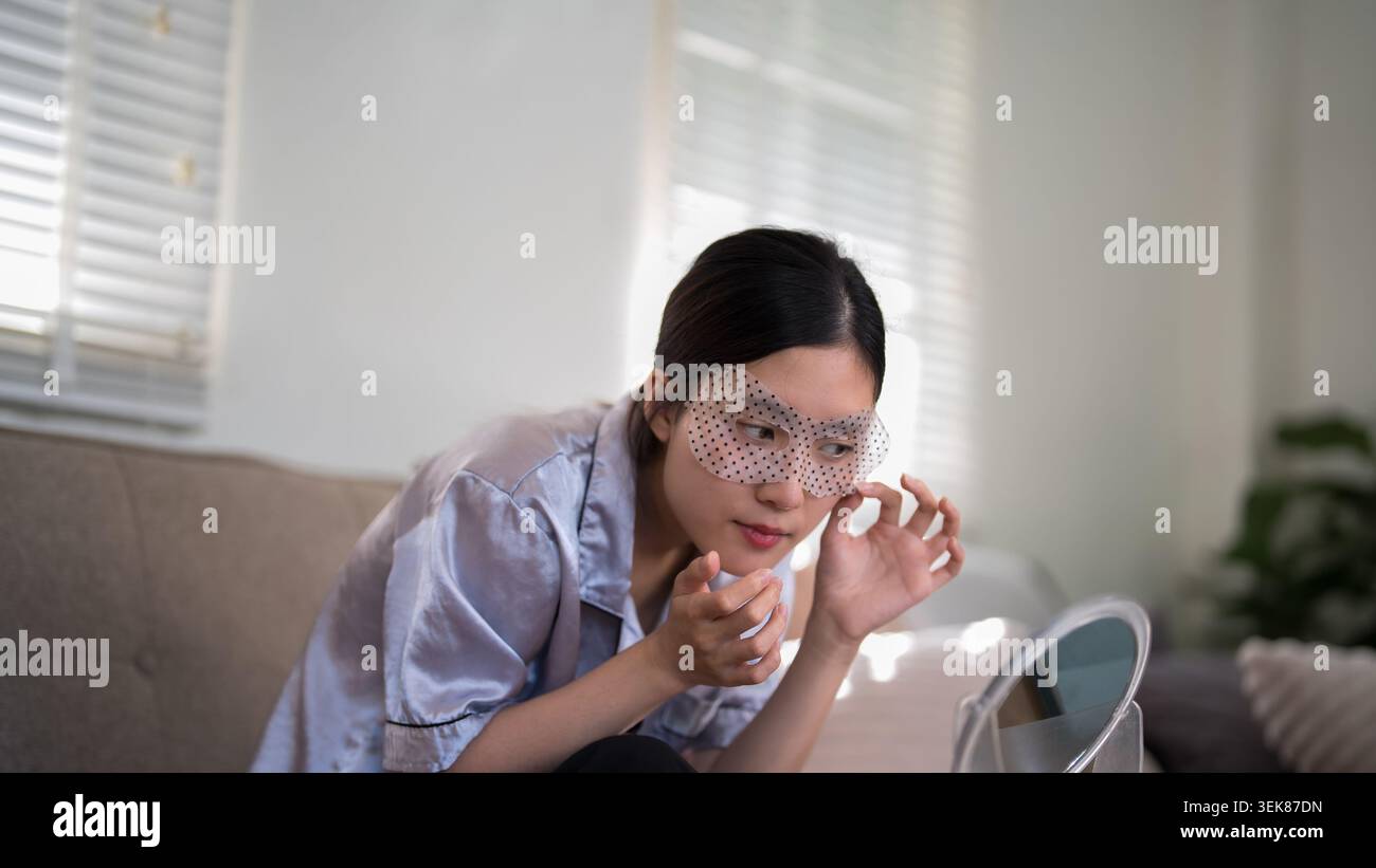 Asian woman applying eye mask patches for skincare beauty treatment at ...
