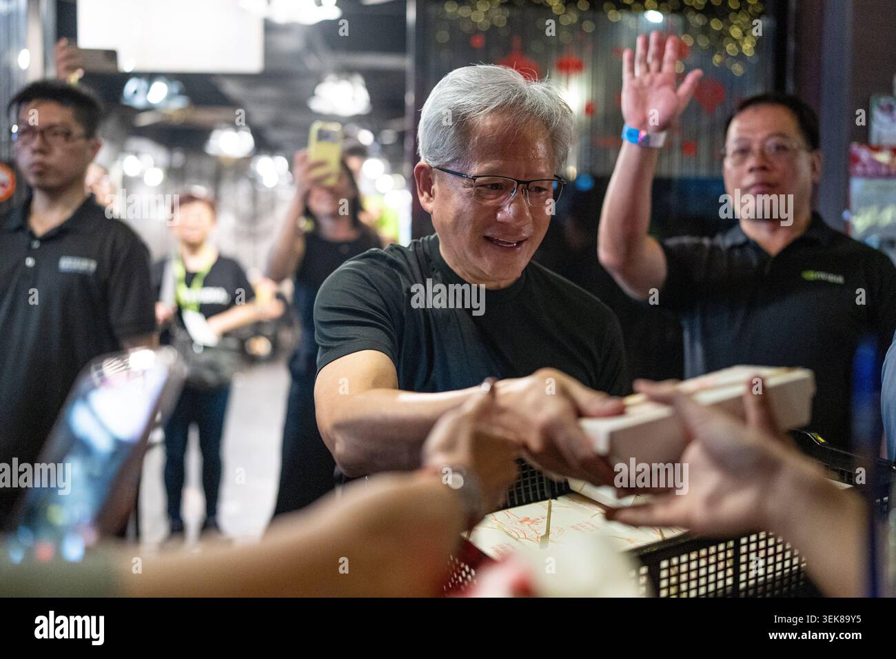 Jensen Huang, President and CEO of NVIDIA handing out food to fans ...