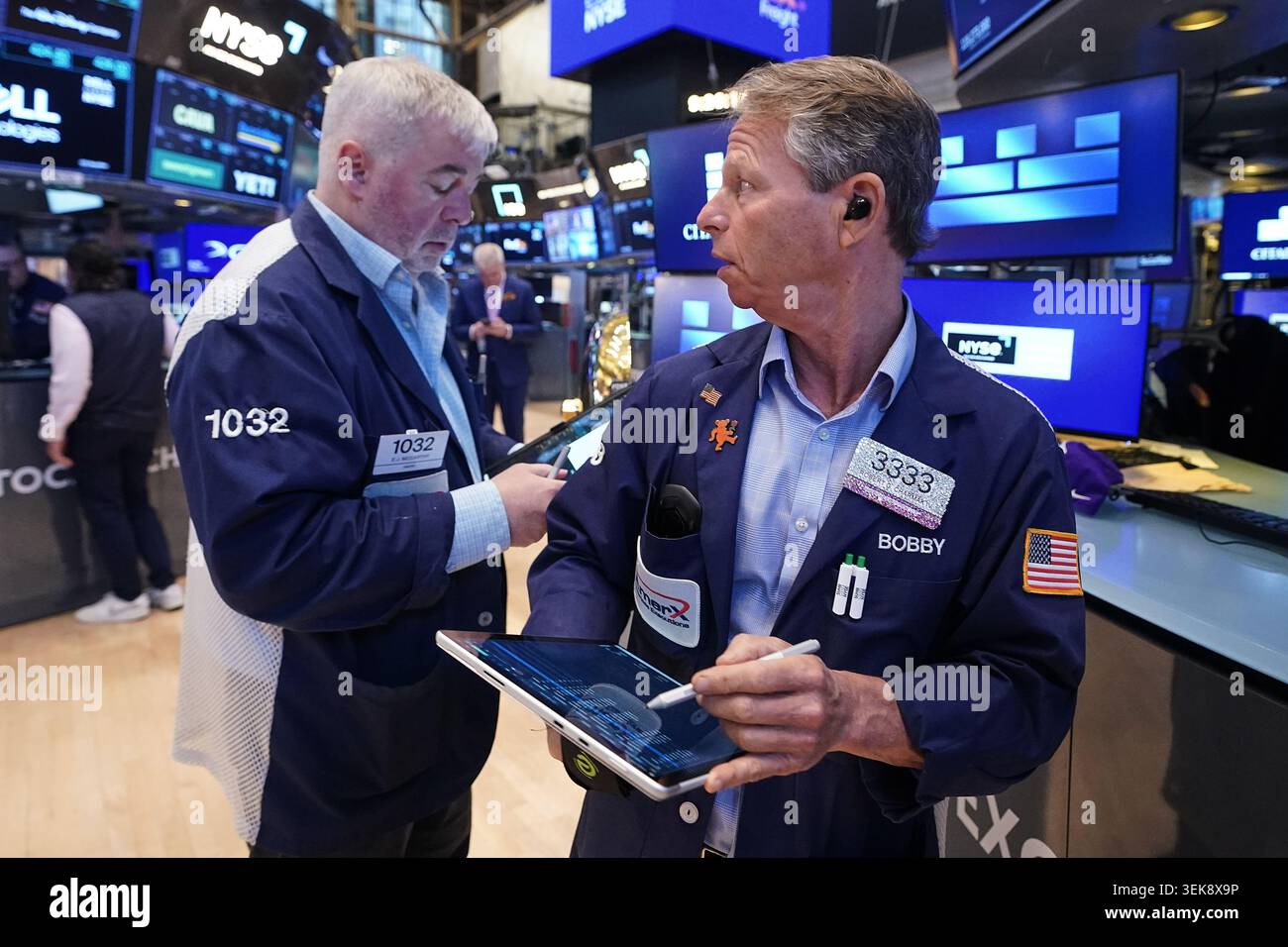 Traders Edward McCarthy, left, and Robert Charmak work on the floor of ...