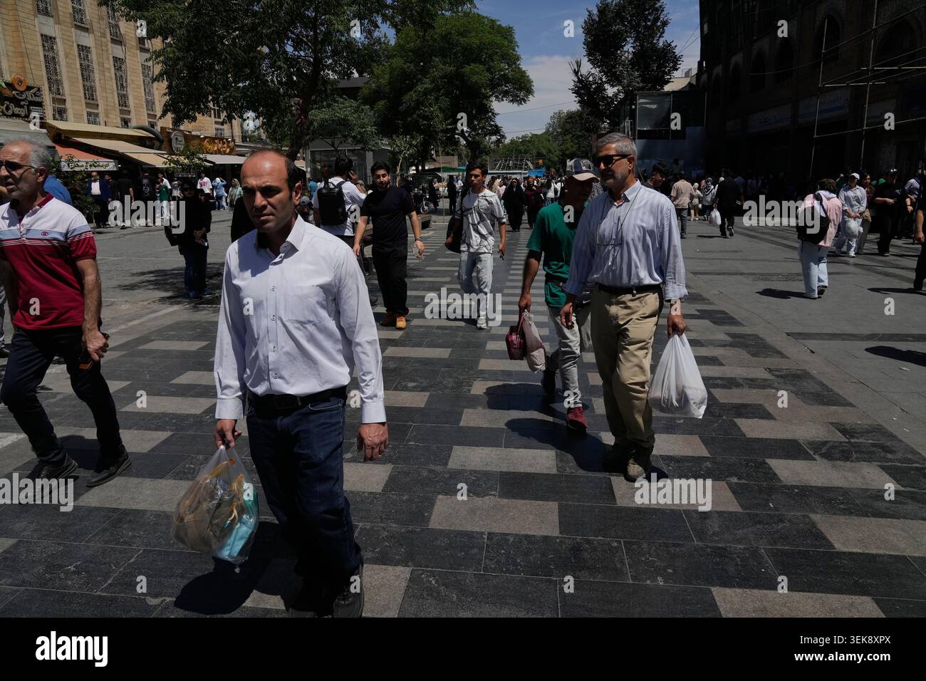 People walk around Tehran's historic Grand Bazaar, Iran, Monday, June 1 ...