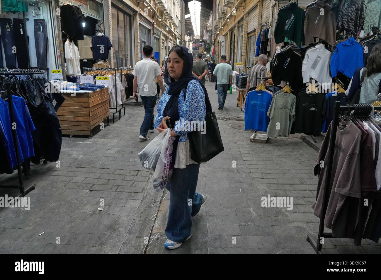 A woman walks at Tehran's historic Grand Bazaar, Iran, Monday, June 1 ...