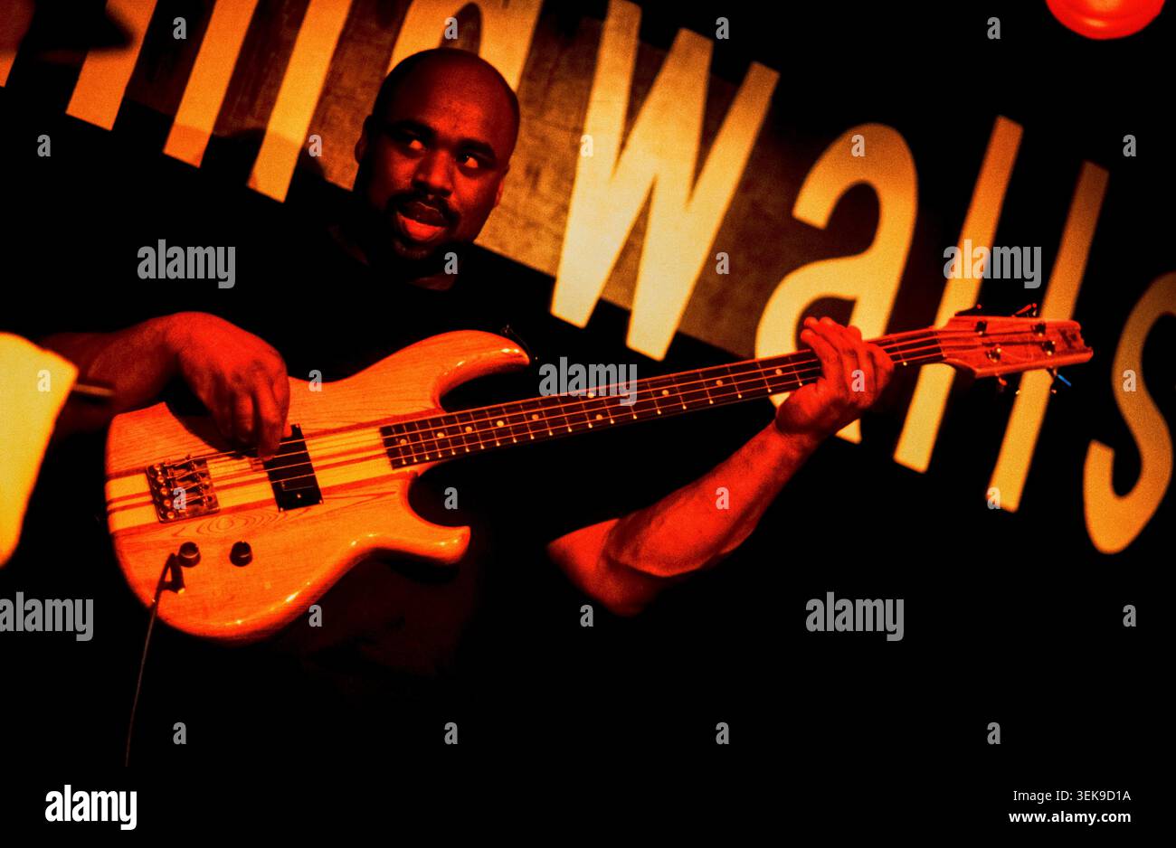 Wayne Batchelor playing his electric bass guitar at Dingwalls, Camden ...