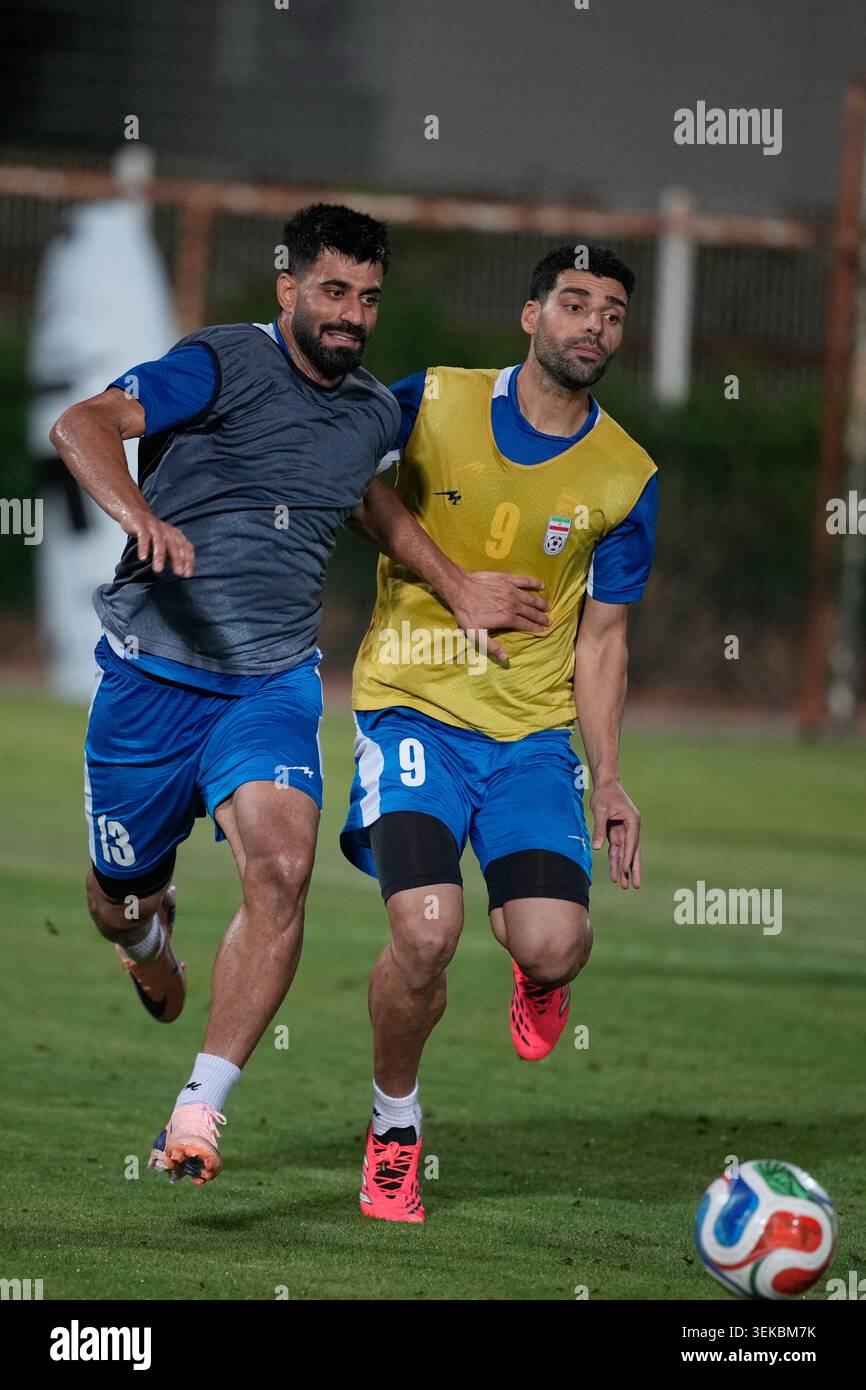 Iran's Mohammadhossein Kananizadegan, left, and Mehdi Taremi fight for ...
