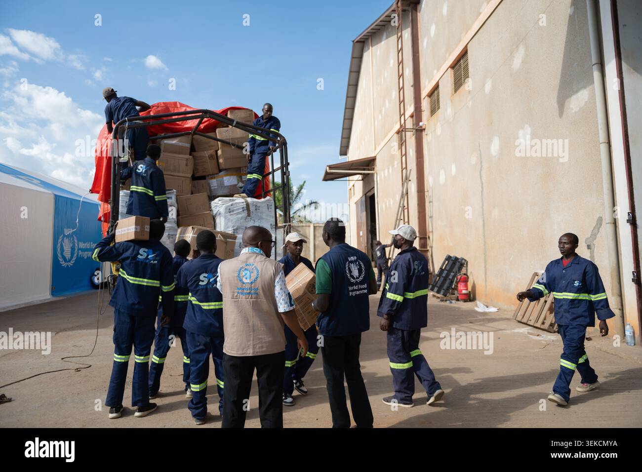 People offload supplies from a truck at the World Food Programme (WFP ...