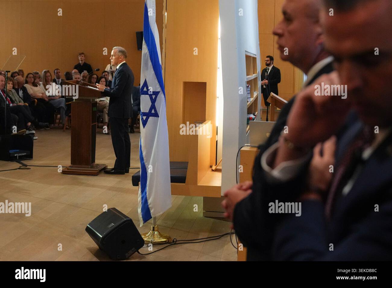 Prime Minister Mark Carney is flanked by members of his security detail ...